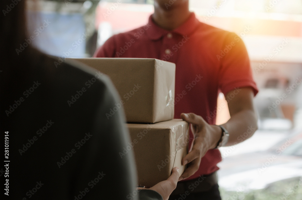 smart home delivery service man in red uniform handing parcel boxes to ...
