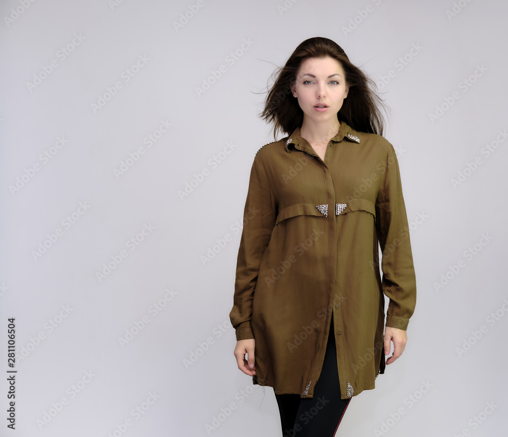 A portrait above the knee of a pretty adult brunette girl in a dress on ...