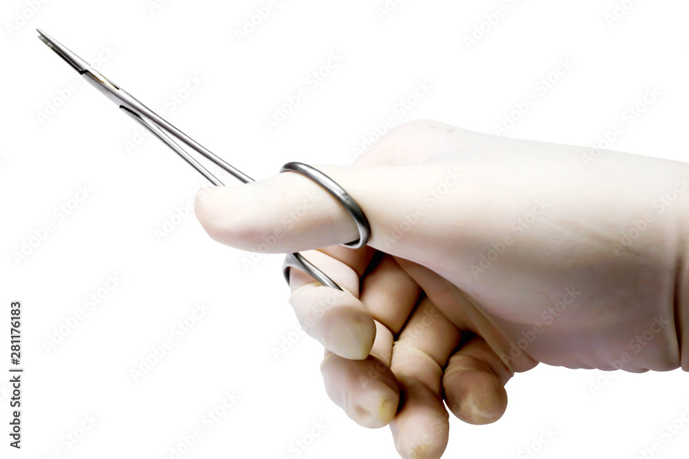 Doctor's hand in the medical latex glove holding medical artery clamp ...