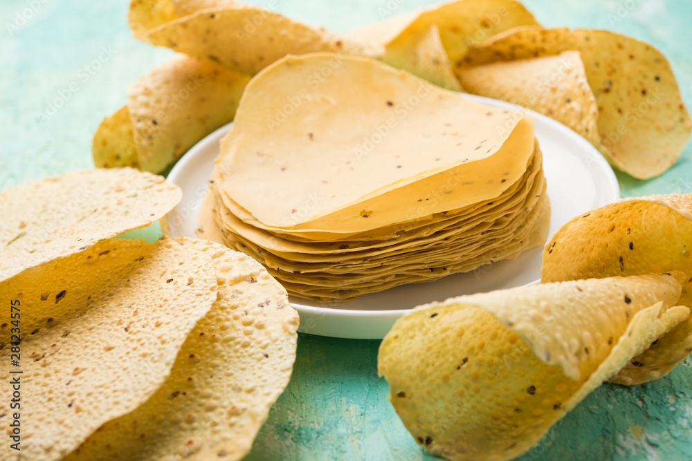 Gujarati papad or papadum in raw dried form with roasted cone, roll and ...
