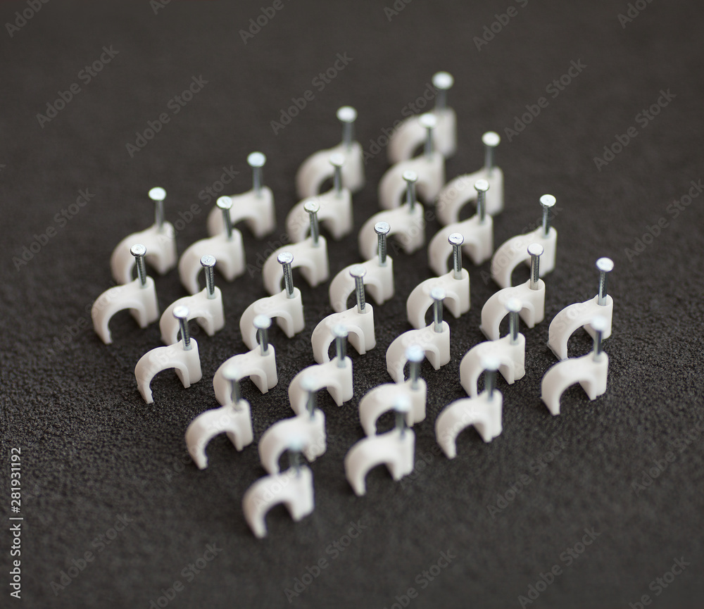 Plastic fastenings for cables in ranks and columns Stock Photo | Adobe ...