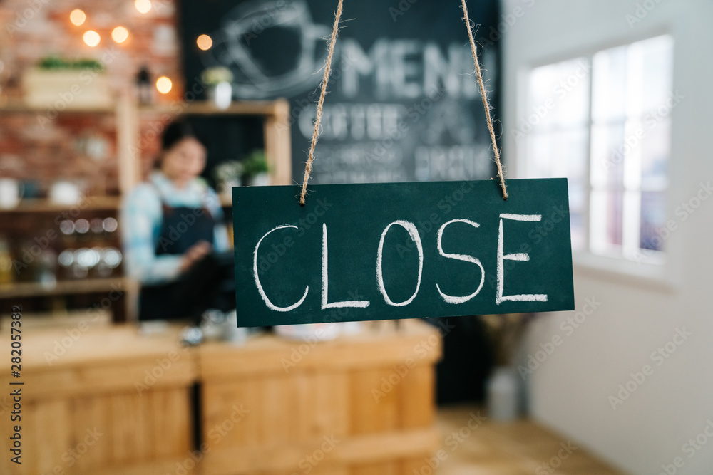 focus on close sign board through glass of store window in cafe bar ...
