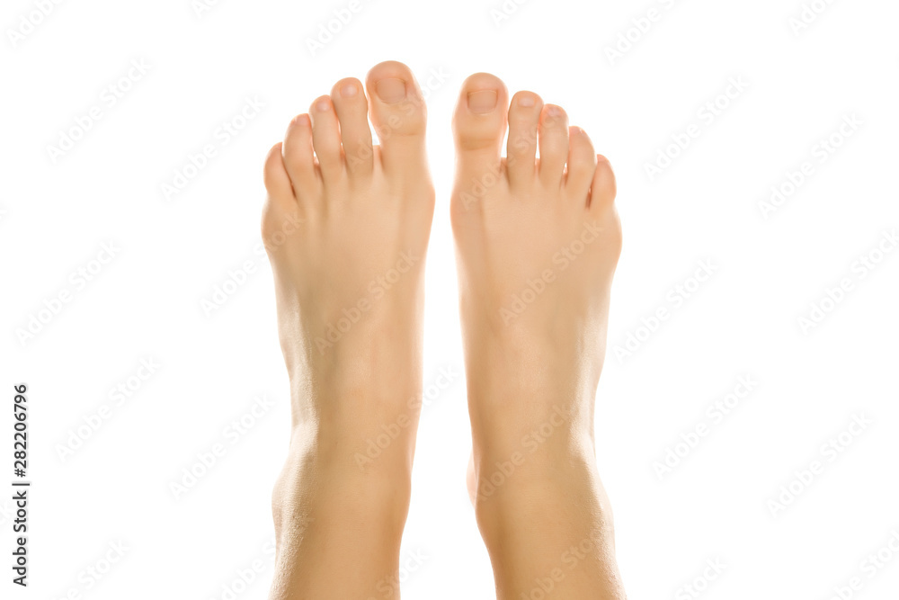 Young woman's beautiful bare feet and toes top view. Closeup isolated ...