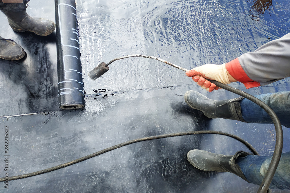 Professional installation of waterproofing on the concrete foundation ...