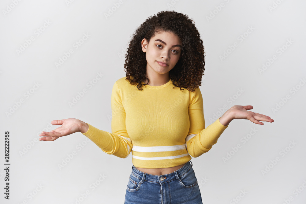 Got no clue. Unaware unbothered cheeky young female coworker shrugging ...