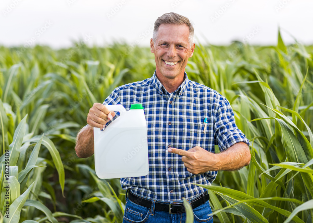 Smiley man pointing at an insecticide canister Stock Photo | Adobe Stock