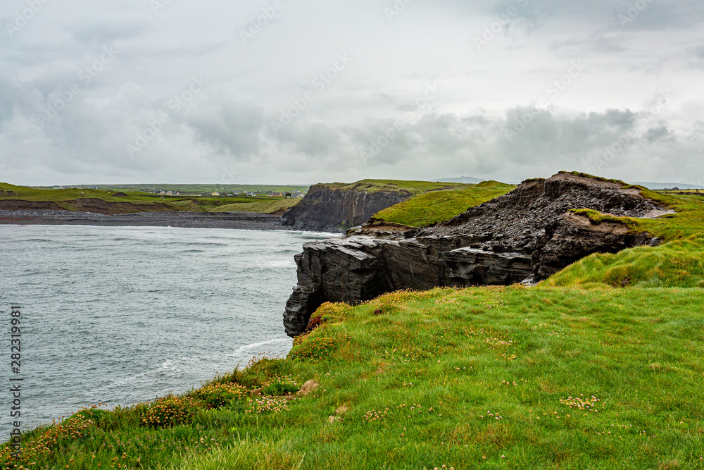 Limestone rock Cliffs and the sea along the coastal walk route from ...
