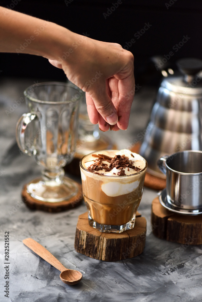 Making coffee cocktail. Slender woman hand decorating coffee with ...