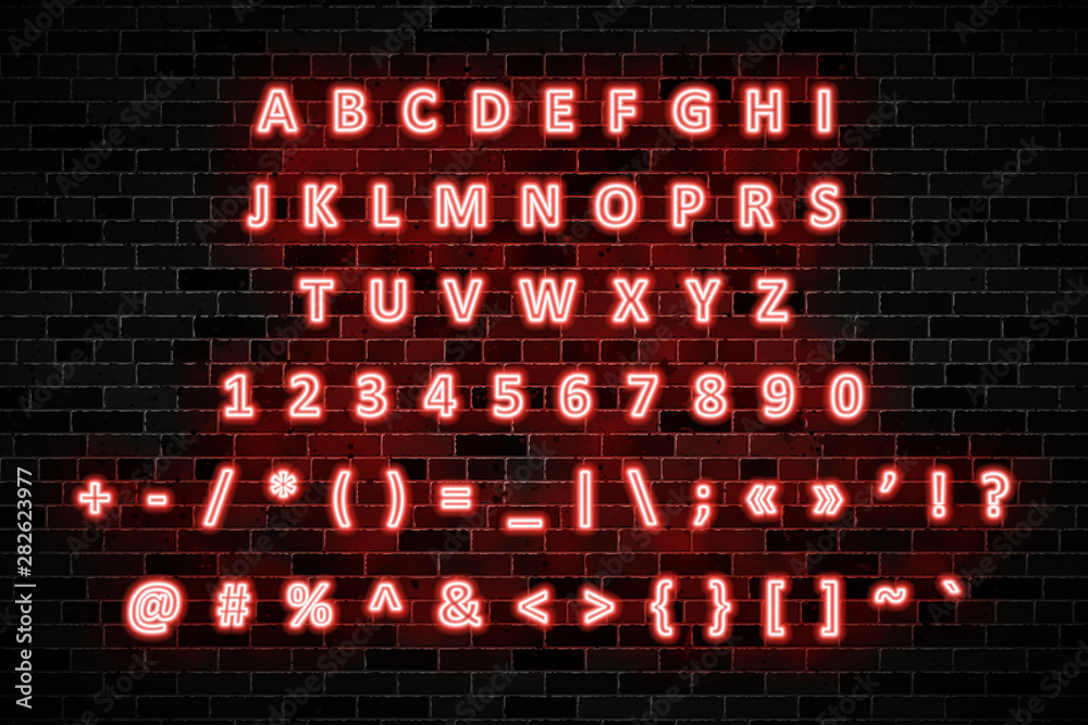 red neon signs capital letters, numbers and symbols on dark brick wall ...