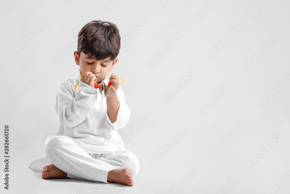 Indian Little Boy in Traditional Dress and learning with Musical ...