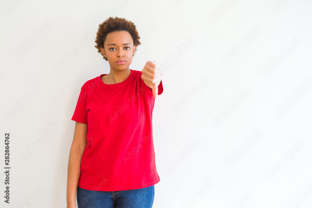 Young beautiful african american woman over white background looking ...