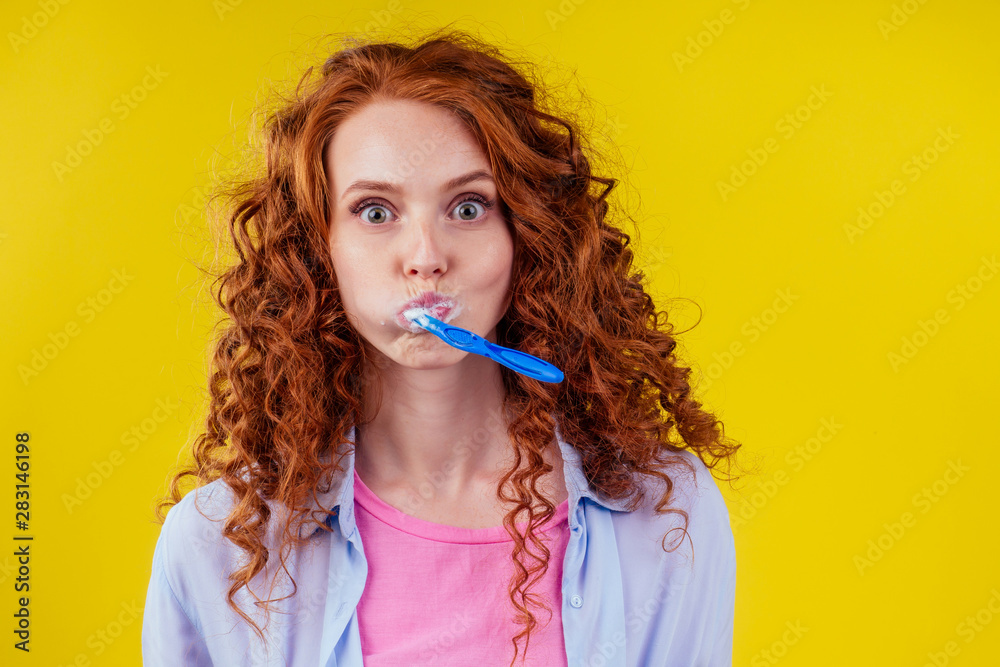 sleepy redhaired ginger woman brushing teeth with toothpaste eco paste ...