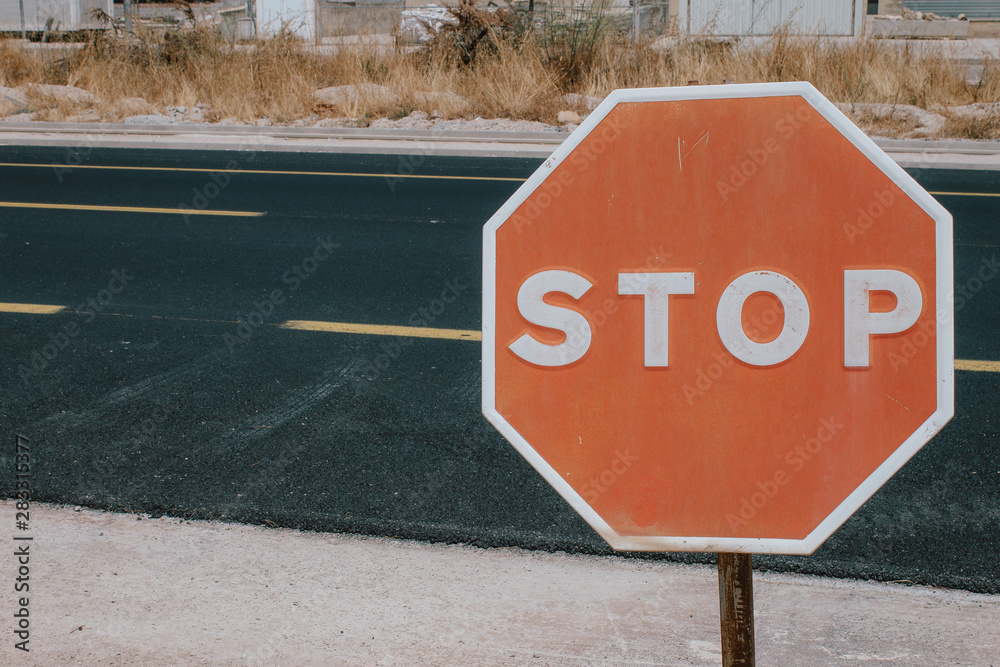 road stop sign in the middle of an industrial estate. signal to protect ...