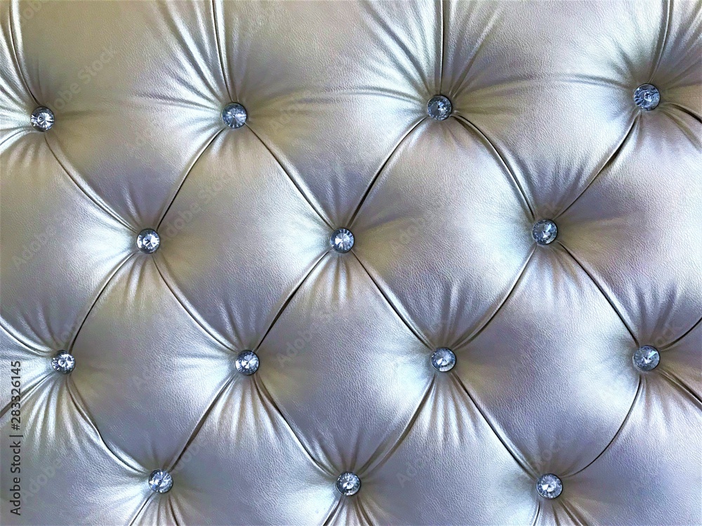Silver leather upholstery screed tightened with rhinestone buttons ...