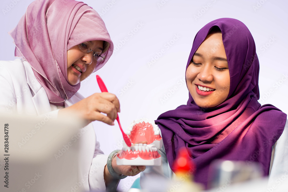 female muslim hijab dentist explained how to brush teeth corectly with ...