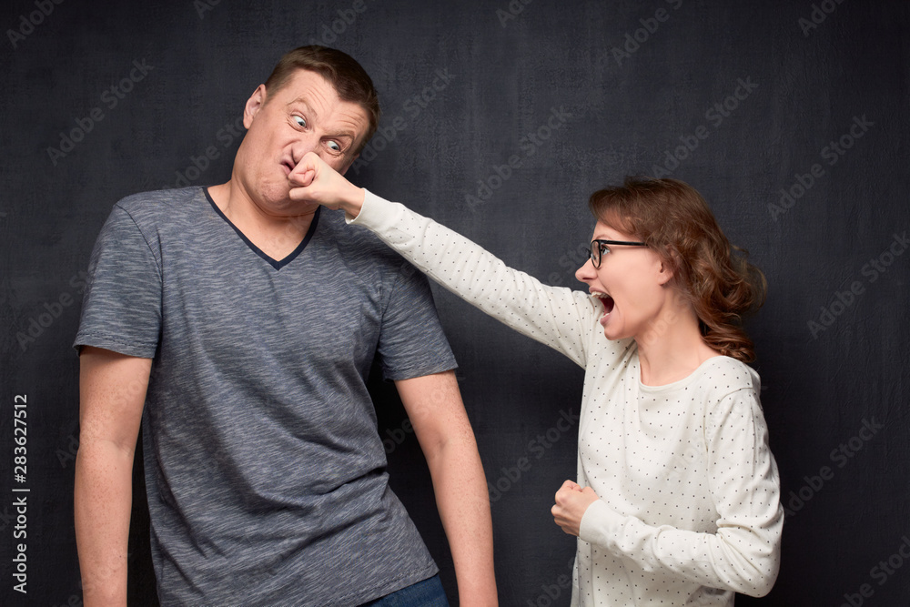 Furious woman is screaming and punching on the nose of man Stock Photo ...