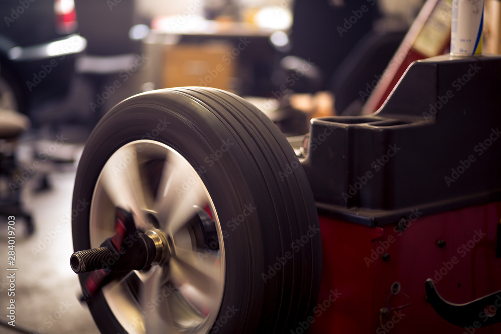 Car tires being changed in garage because of winter season. Workplace ...