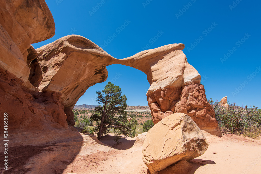 Landscape of massive red and tan slick rock arch at Devils Garden in ...