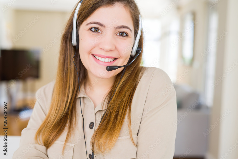 Beautiful young operator woman wearing headset at the office with a ...