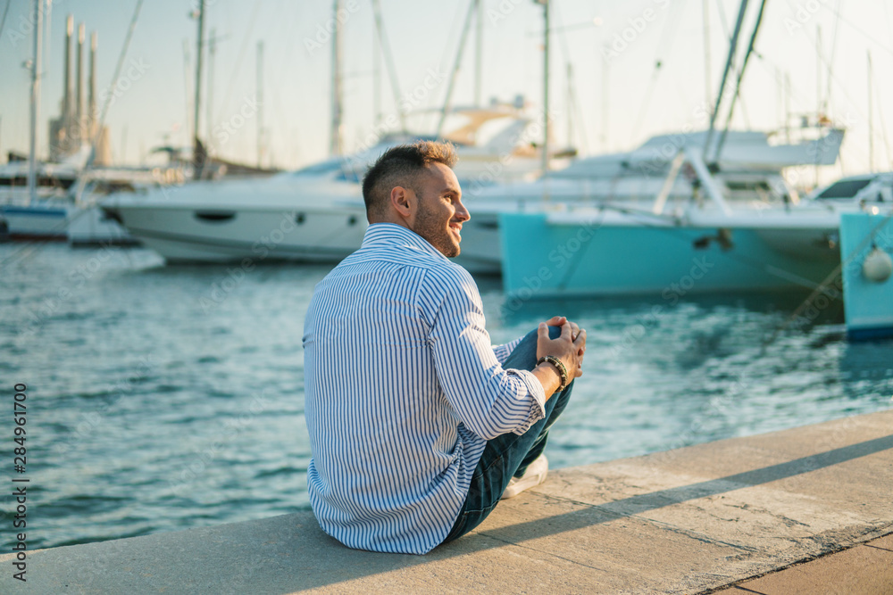 Young rich man at Yacht Club. Businessman is Relaxing in the gulf with ...
