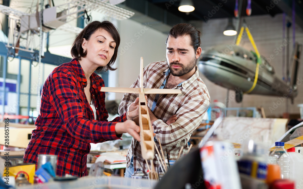 Positive couple enjoying their hobbies - modeling light airplanes in ...