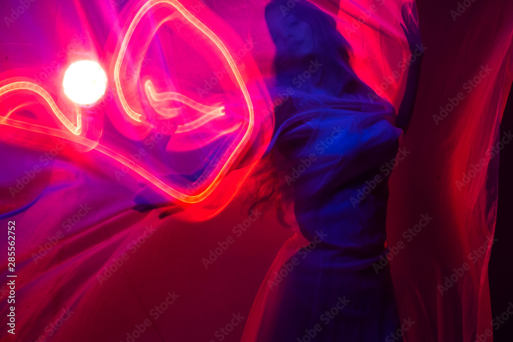 Attractive dancing girl in the club, neon light, motion effects. Black ...