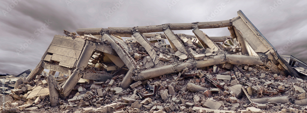 Collapsed concrete industrial building with dramatic sky and another ...