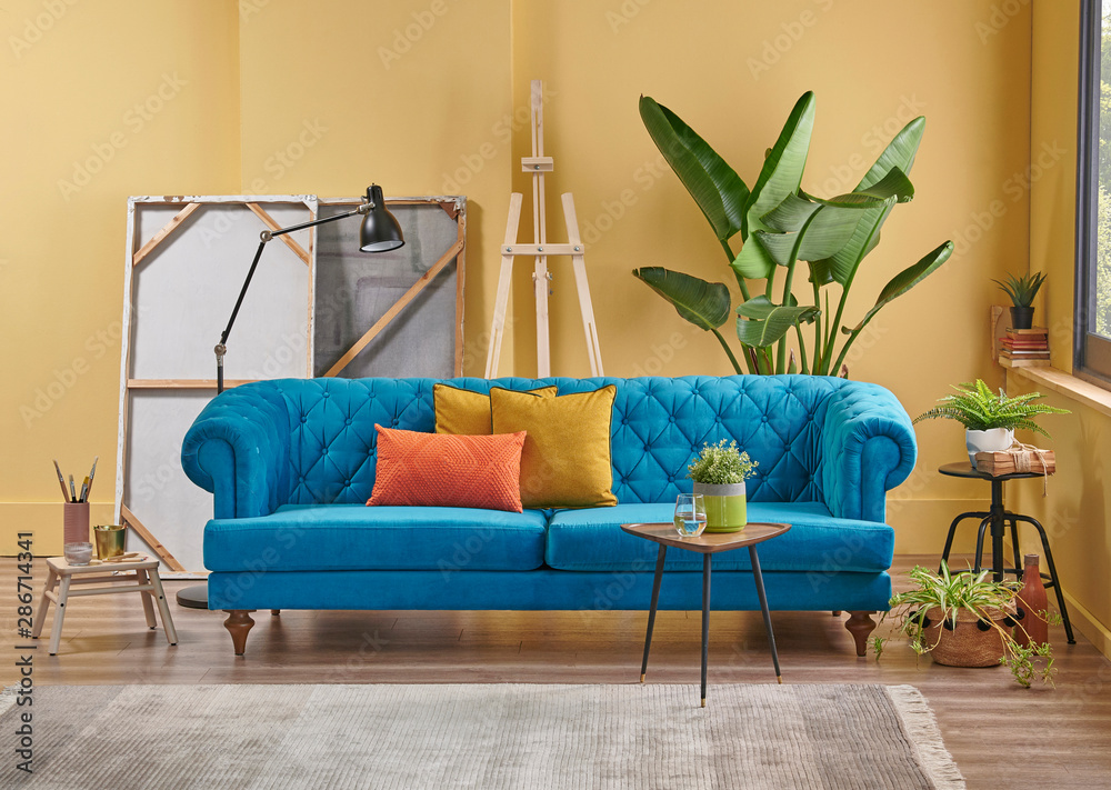Stock Foto Modern yellow living room blue classic sofa easel and painting style frame vase of plant and interior decoration. Adobe Stock