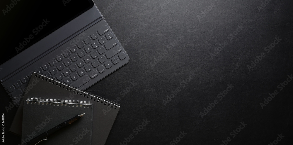 Dark stylish workplace with laptop computer and office supplies on ...