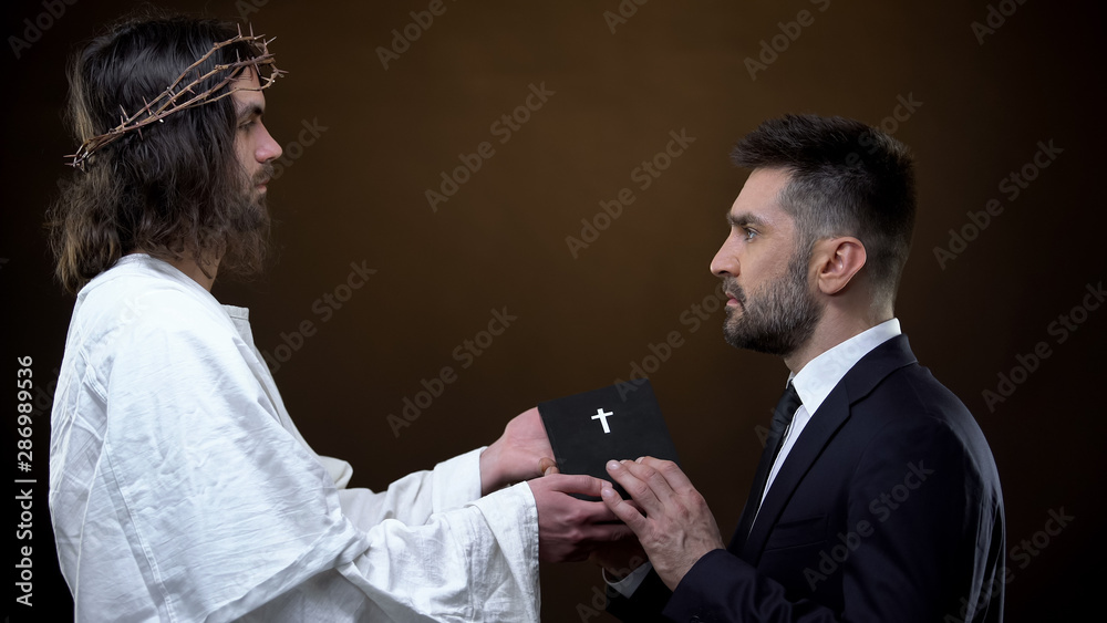 Jesus Christ giving bible to businessman, moral values, religious ...
