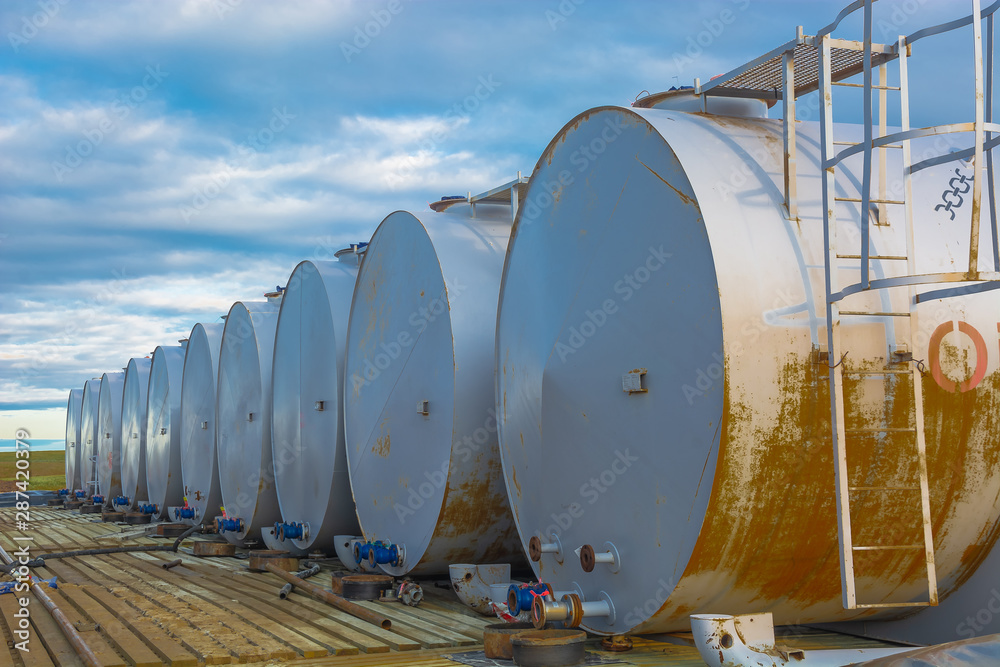 Horizontally located cylindrical tanks with oil products and fuel for ...