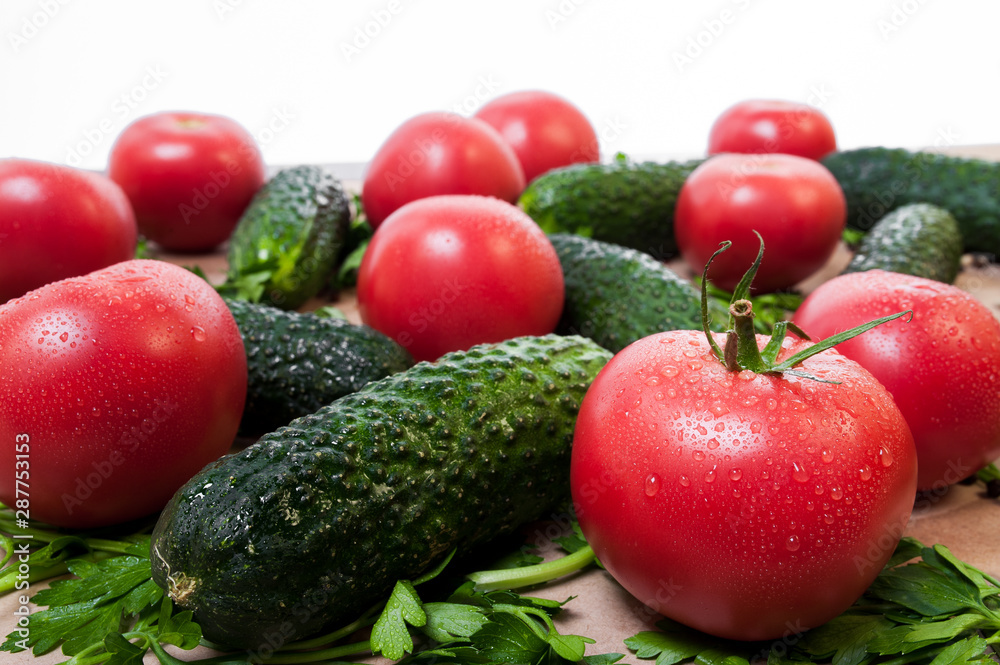 Organic vegetables tomatoes cucumbers parsley over craft paper. Zero ...
