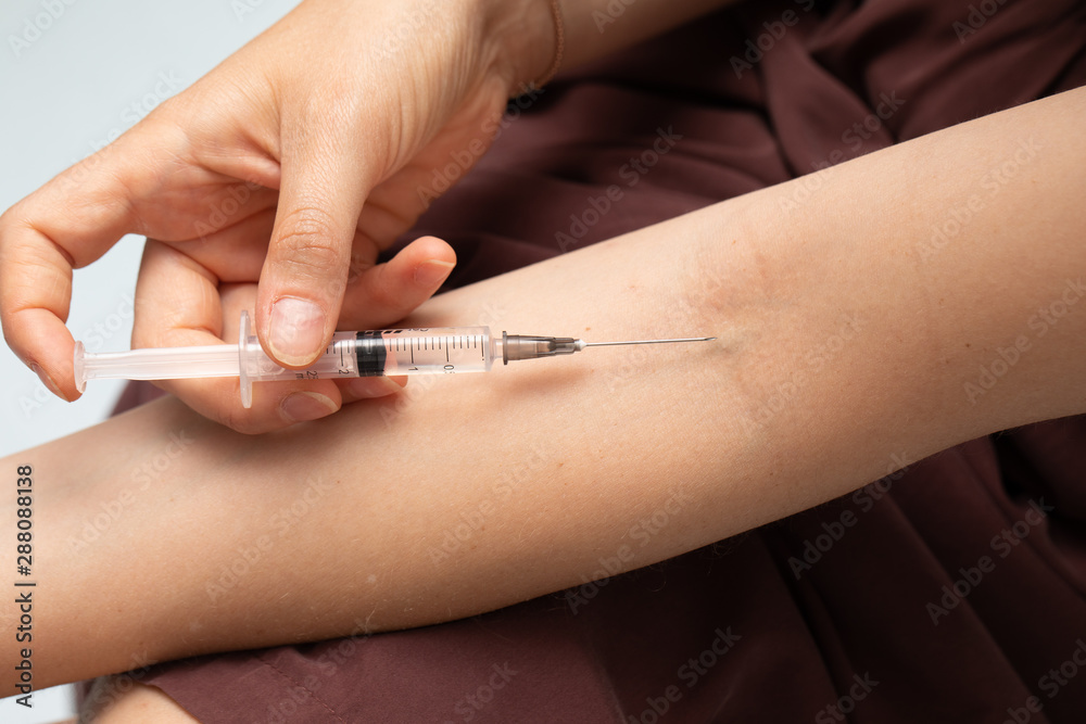 Drug and heroin misuse and abuse concept is seen as a young woman ...