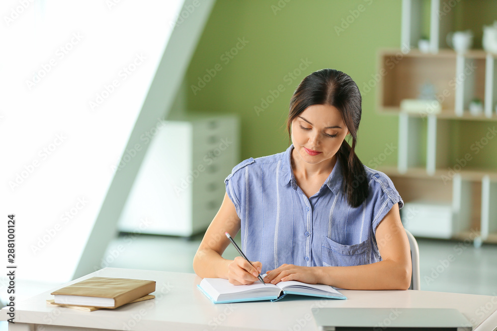 Beautiful young woman making notes at home Stock Photo | Adobe Stock