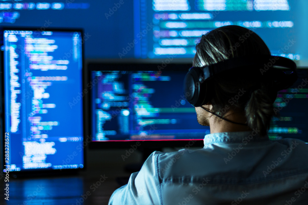 Software developer freelancer man male in headphones work with program code C++ Java Javascript ...