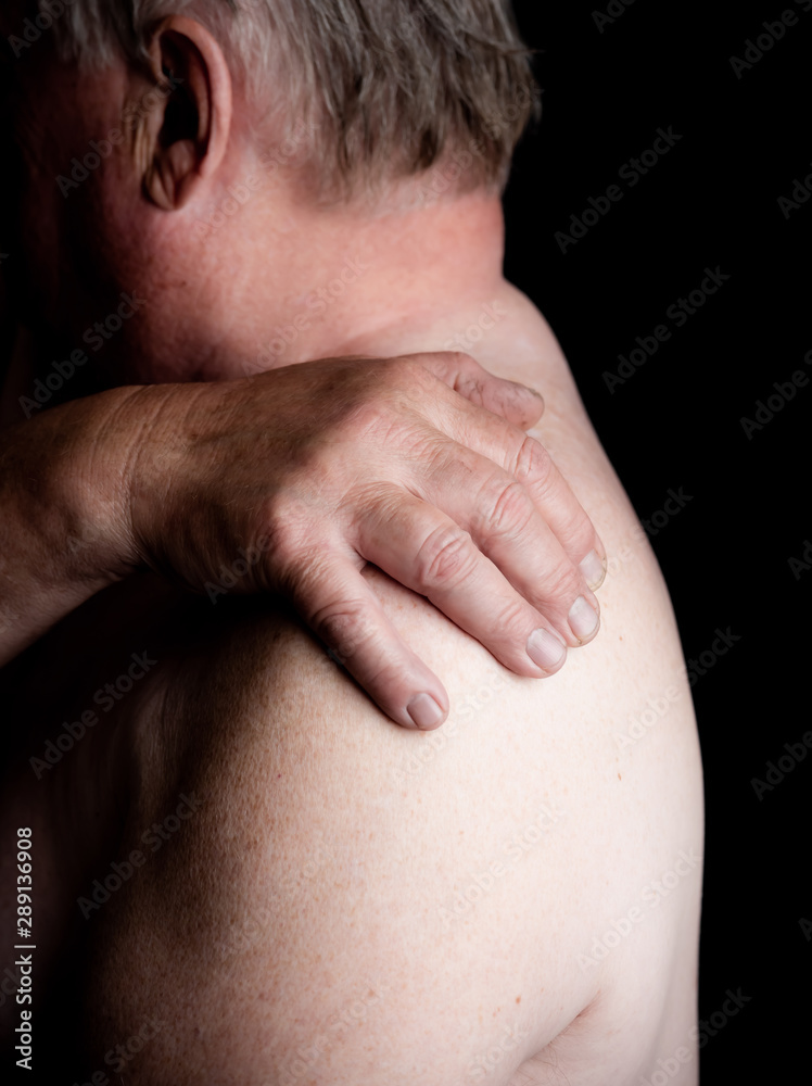 image of older man with shoulder pain. isolated image of neck, shoulder ...