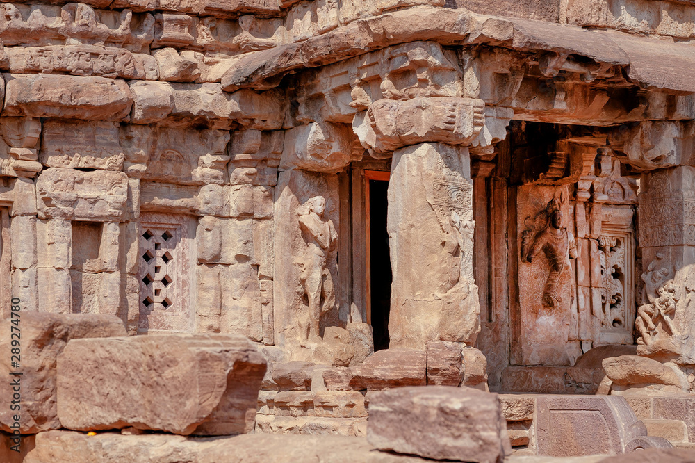 Stone columns and textured walls with sculptures of Hindu temple, India ...