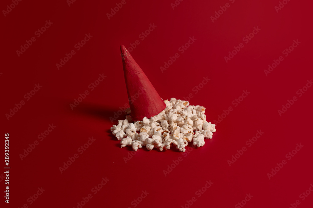 Popcorn in an ice cream cone on a red background. Christmas concept ...