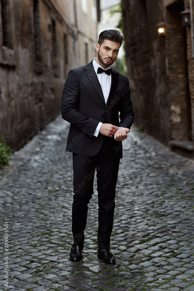 Businessman with james bond dress in little street in Rome Stock Photo ...