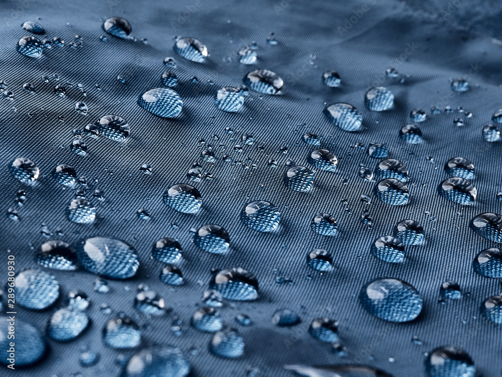 Rain water droplets on blue fiber waterproof fabric. Blue background ...