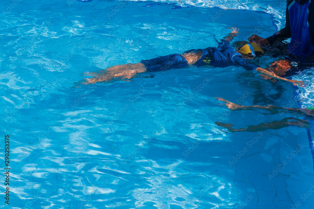 Asian little boy age 5 years old learning basic to swim in the lesson ...
