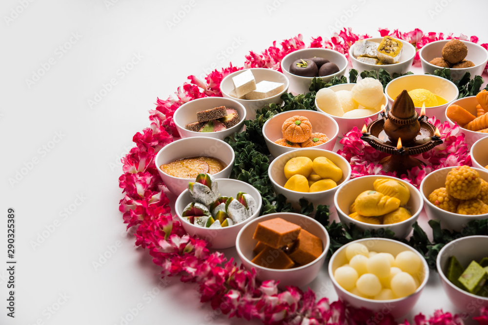 Fotografie Flower Rangoli with sweets/mithai and diya in bowls for ...