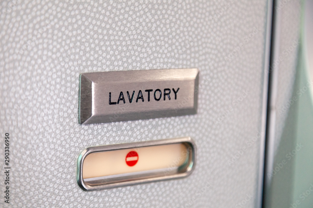 Vacant red sign, occupied symbol on an airplane lavatory door. Raised ...