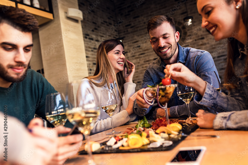 Foto de Stock Group of young friends having fun in restaurant, talking ...