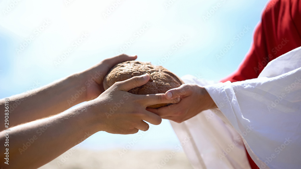 Jesus hands giving bread to poor man, biblical story to feed hungry ...