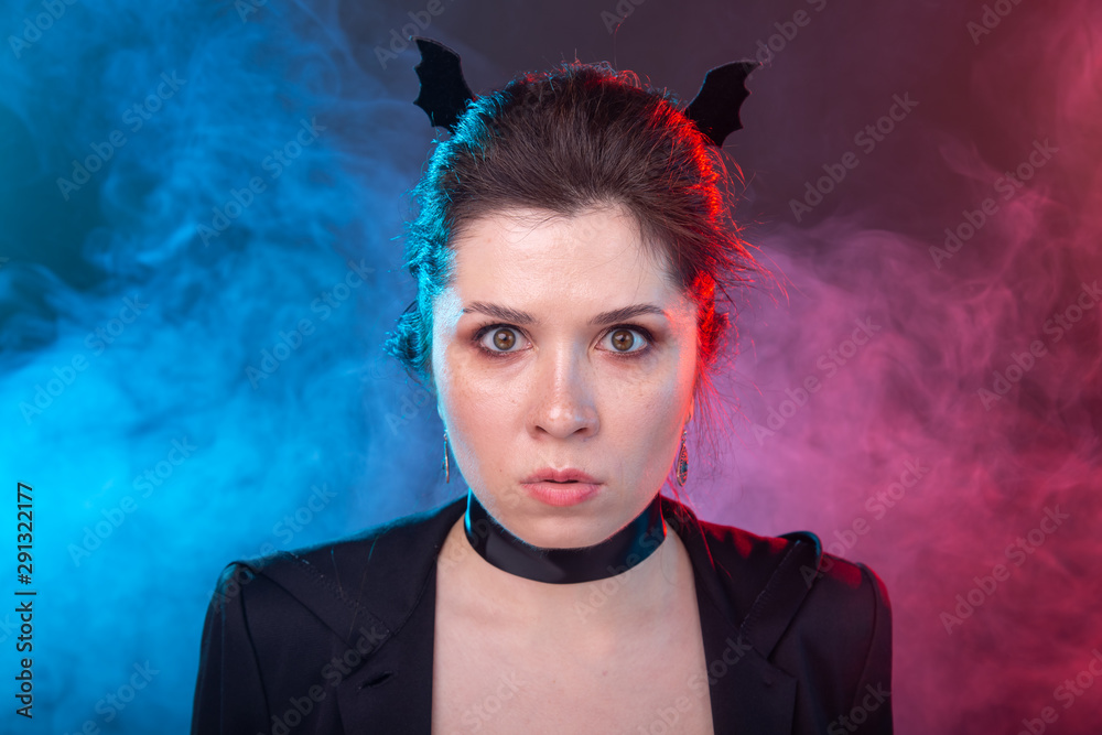 Halloween, holidays and carnival concept - vamp woman in jacket and ...