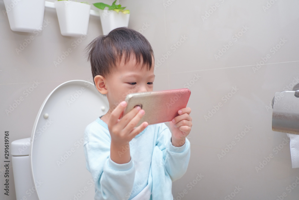 Cute little Asian 3 - 4 years old toddler boy kid using mobile phone ...