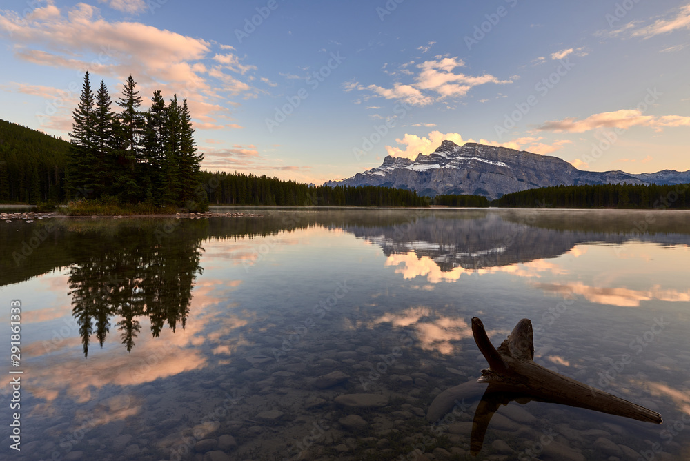 Rundle Mountain reflecting in Two Jack Lake in Banff National Park at ...