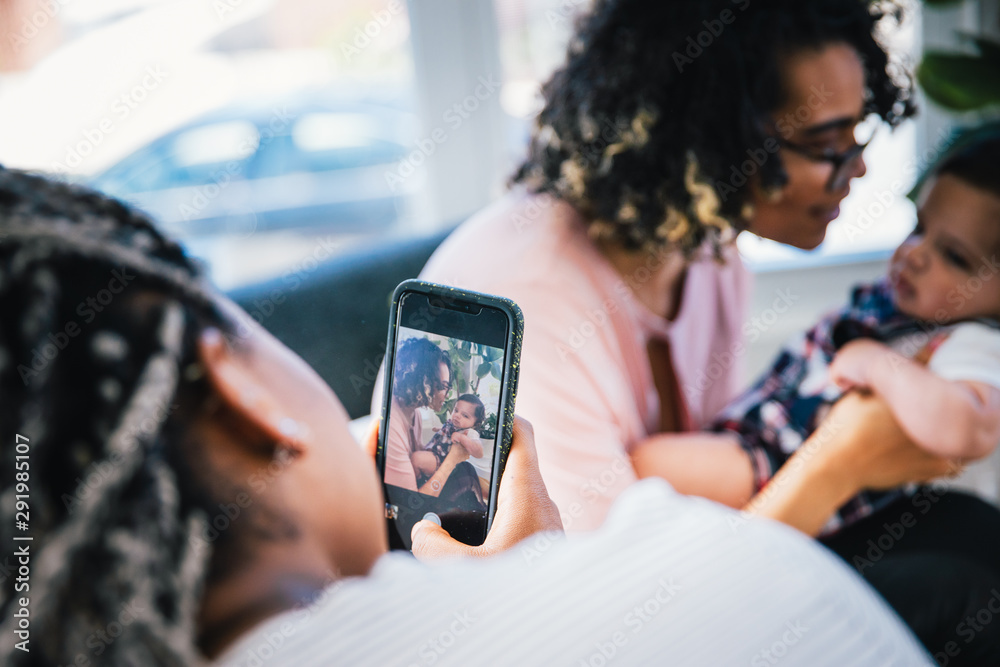 Stock-Foto „Lesbian capturing loving memories through smart phone of ...