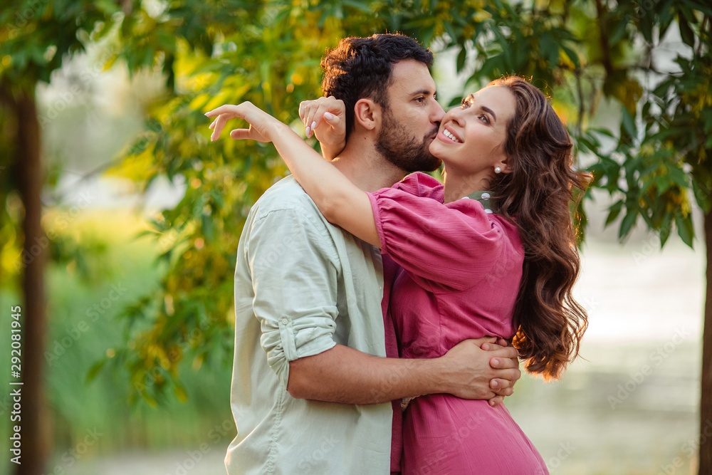 Beautiful young couple man and woman in love with each other hug and ...